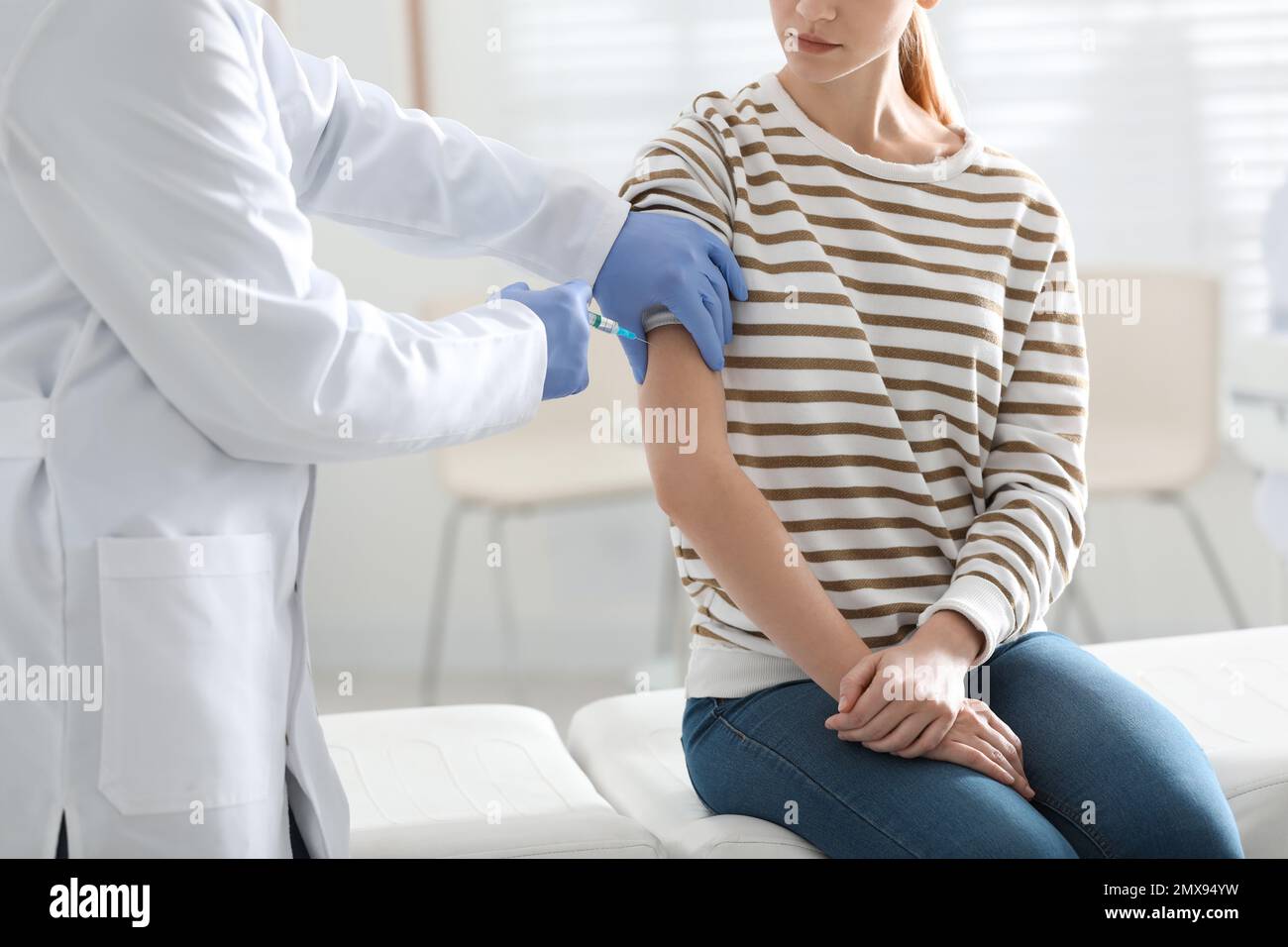 Doctor giving injection to patient in hospital, closeup. Vaccination ...