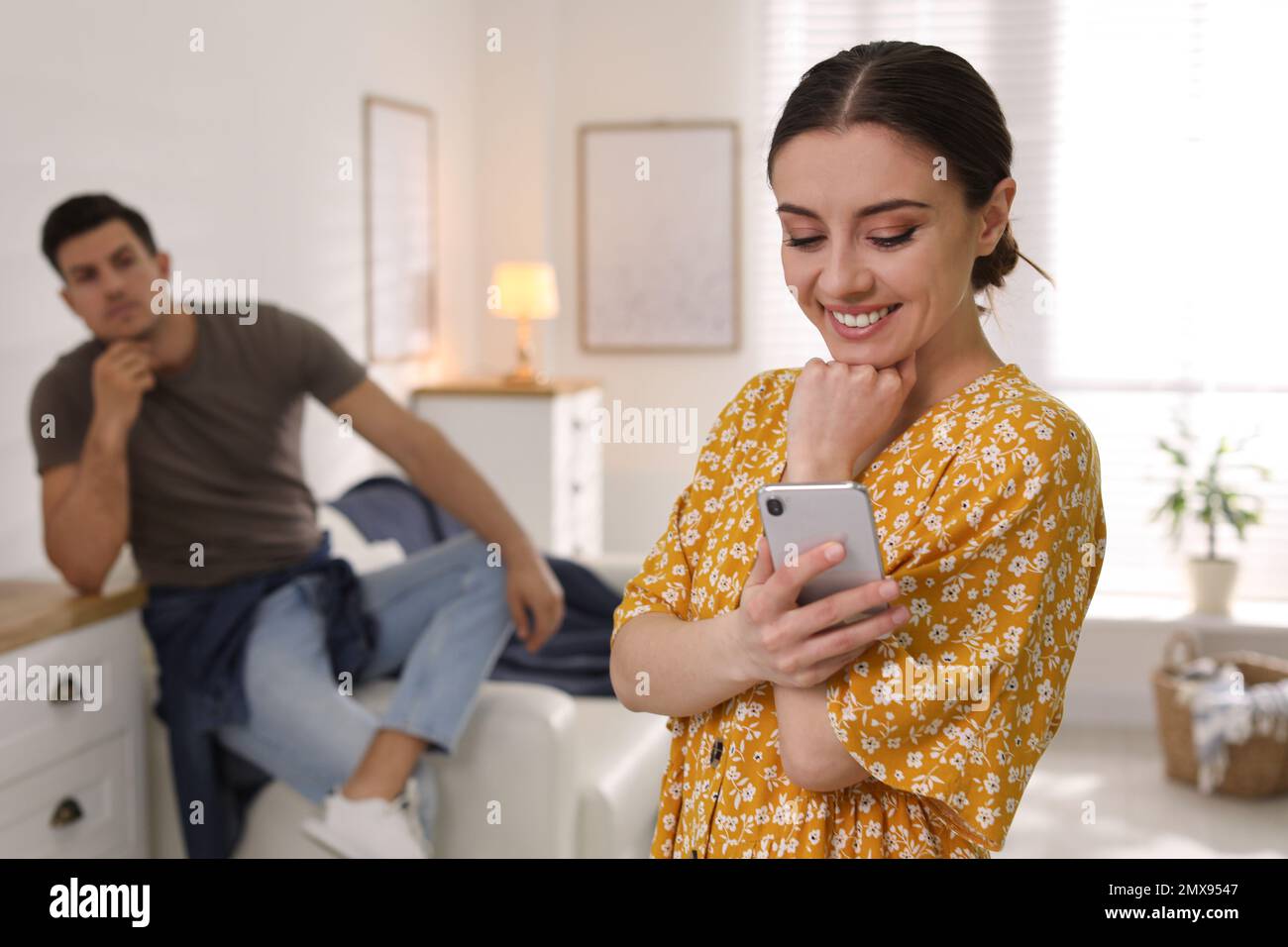 Woman preferring smartphone over spending time with her boyfriend at home. Jealousy in ...