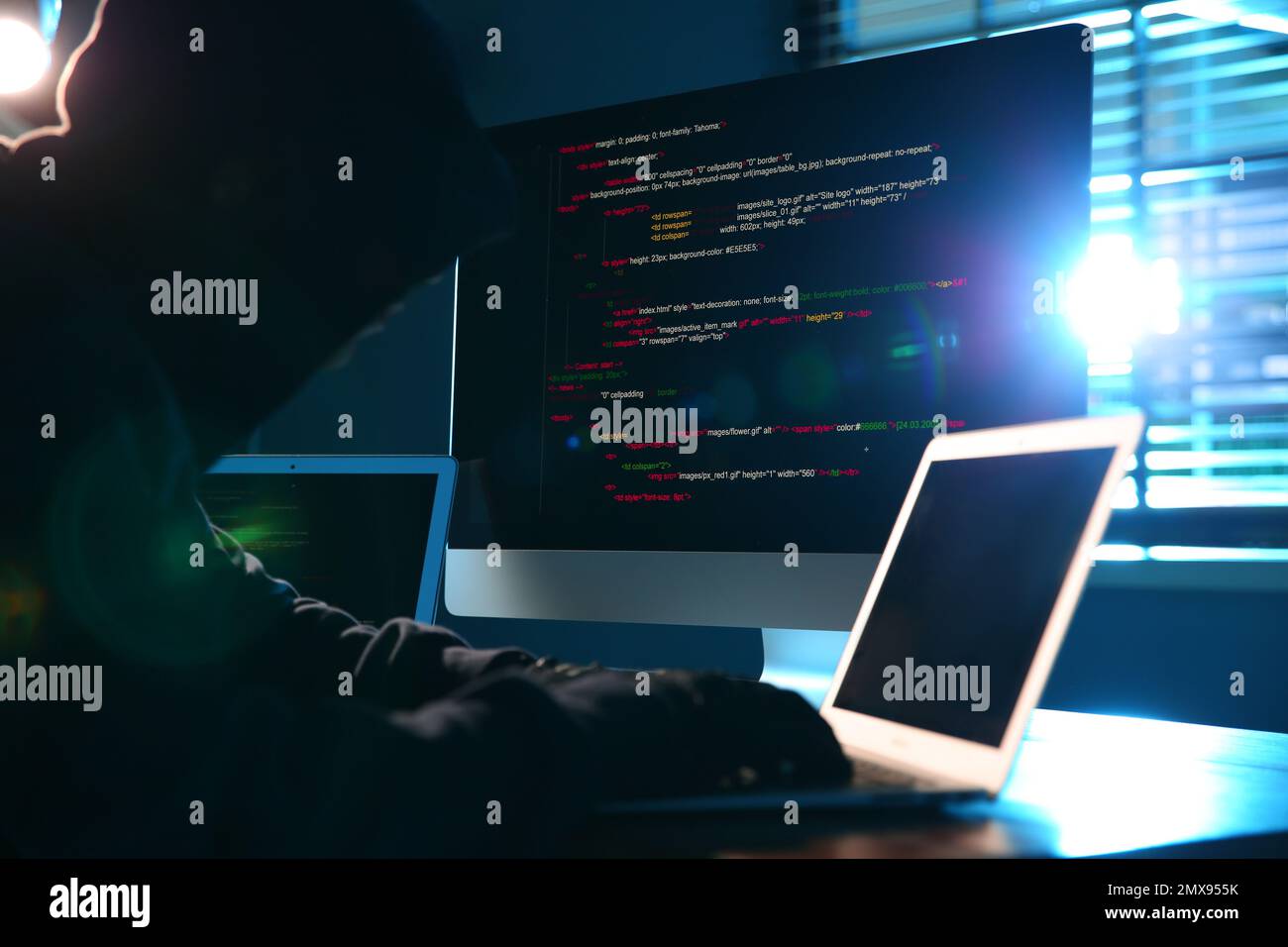 Hacker with computers in dark room. Cyber crime Stock Photo - Alamy