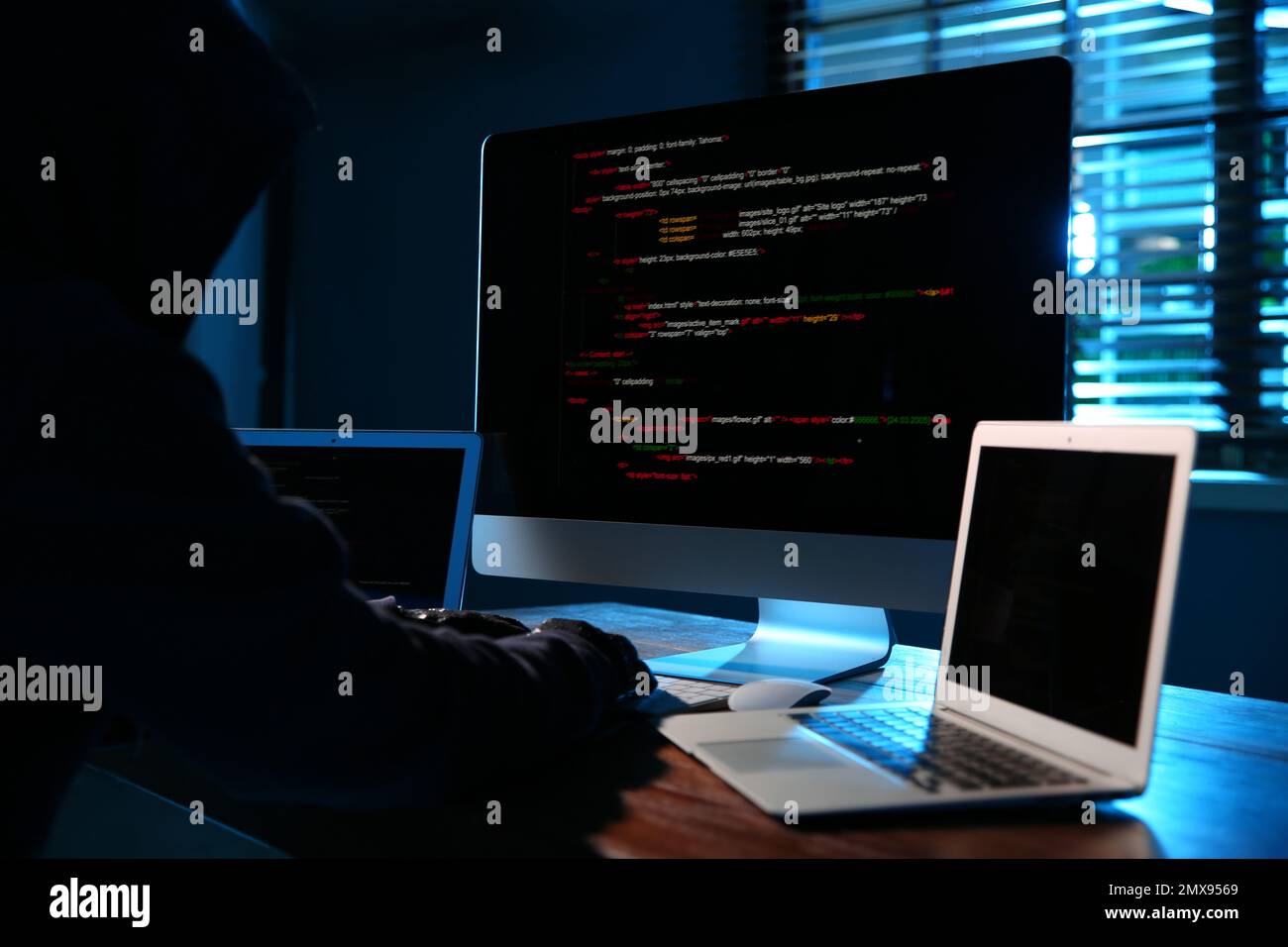 Hacker with computers in dark room. Cyber crime Stock Photo - Alamy