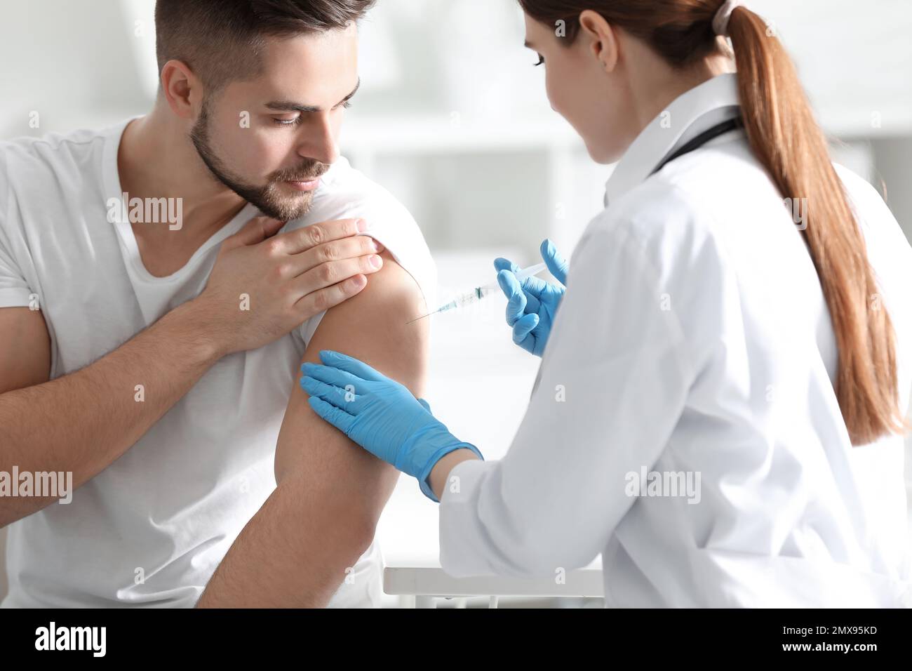 Doctor giving injection to patient in hospital. Vaccination concept ...