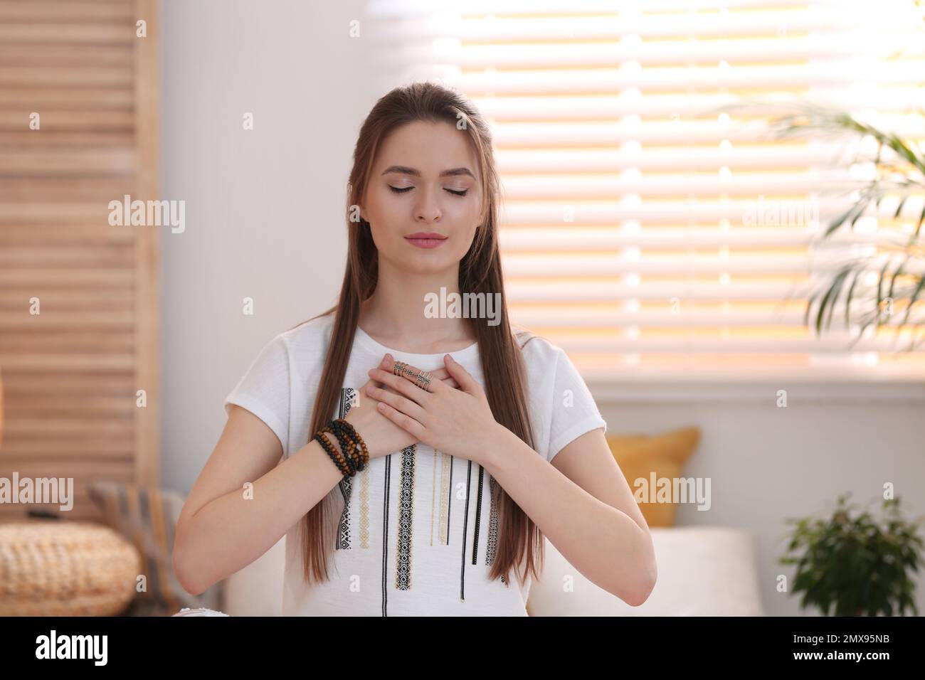 Young woman during self-healing session in therapy room Stock Photo - Alamy