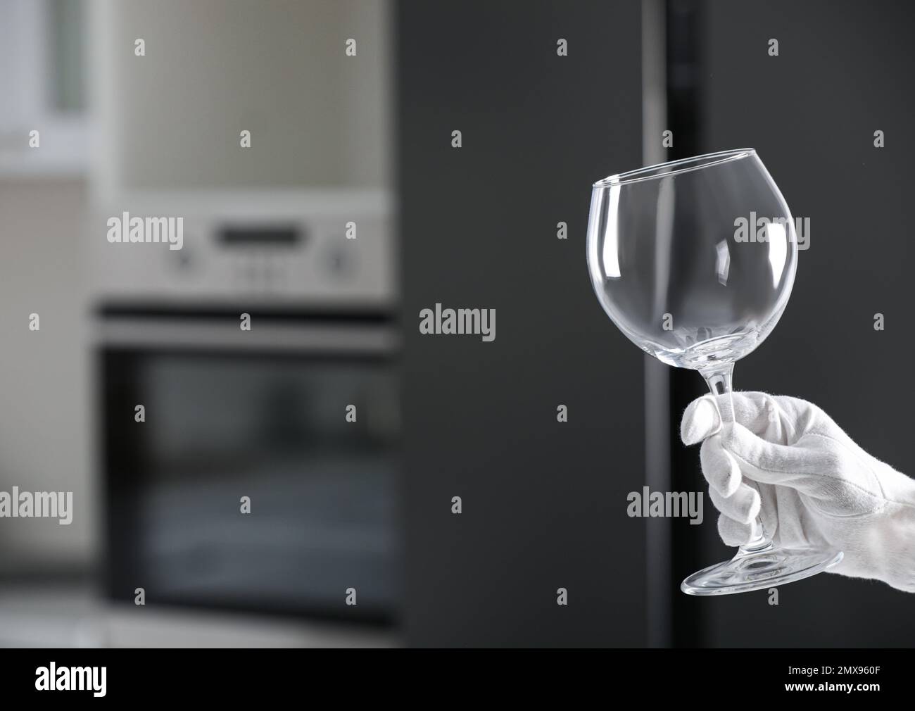 Person in white glove checking cleanliness of glass indoors, closeup ...