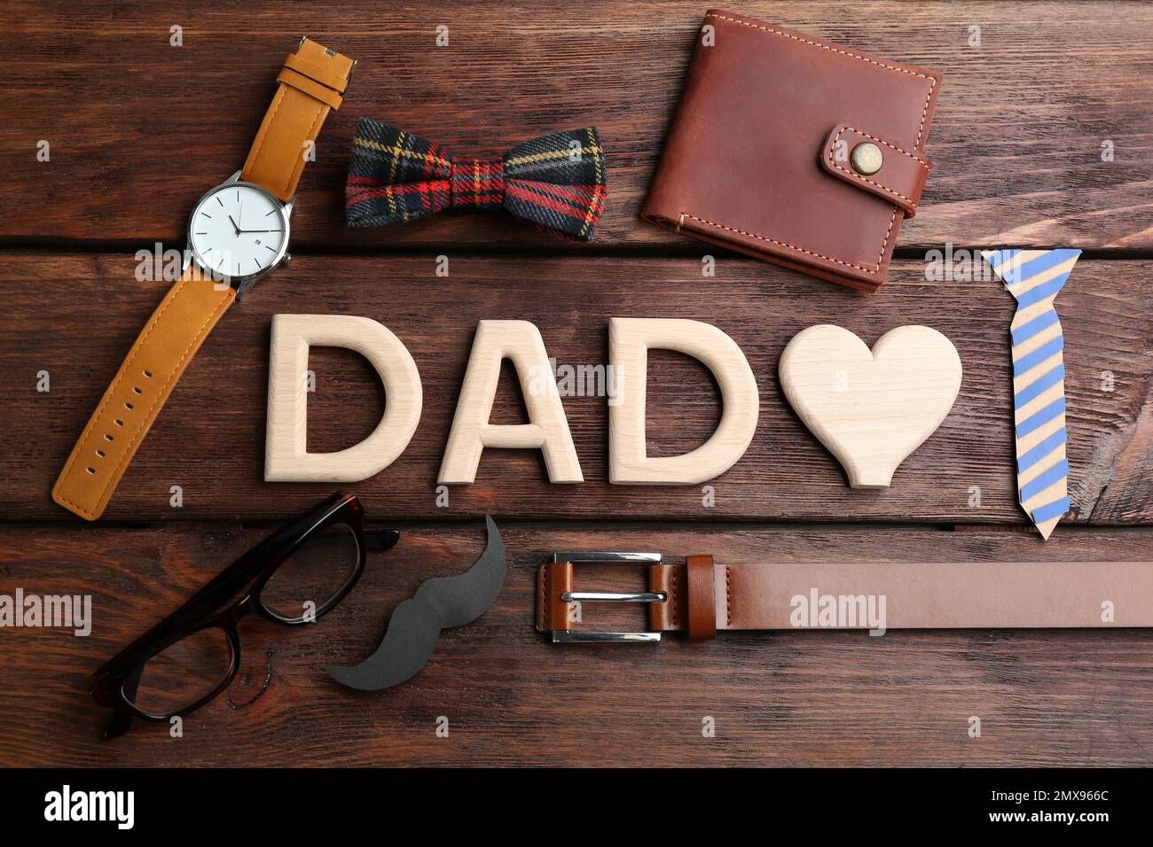 Flat lay composition with word DAD and heart on wooden background ...