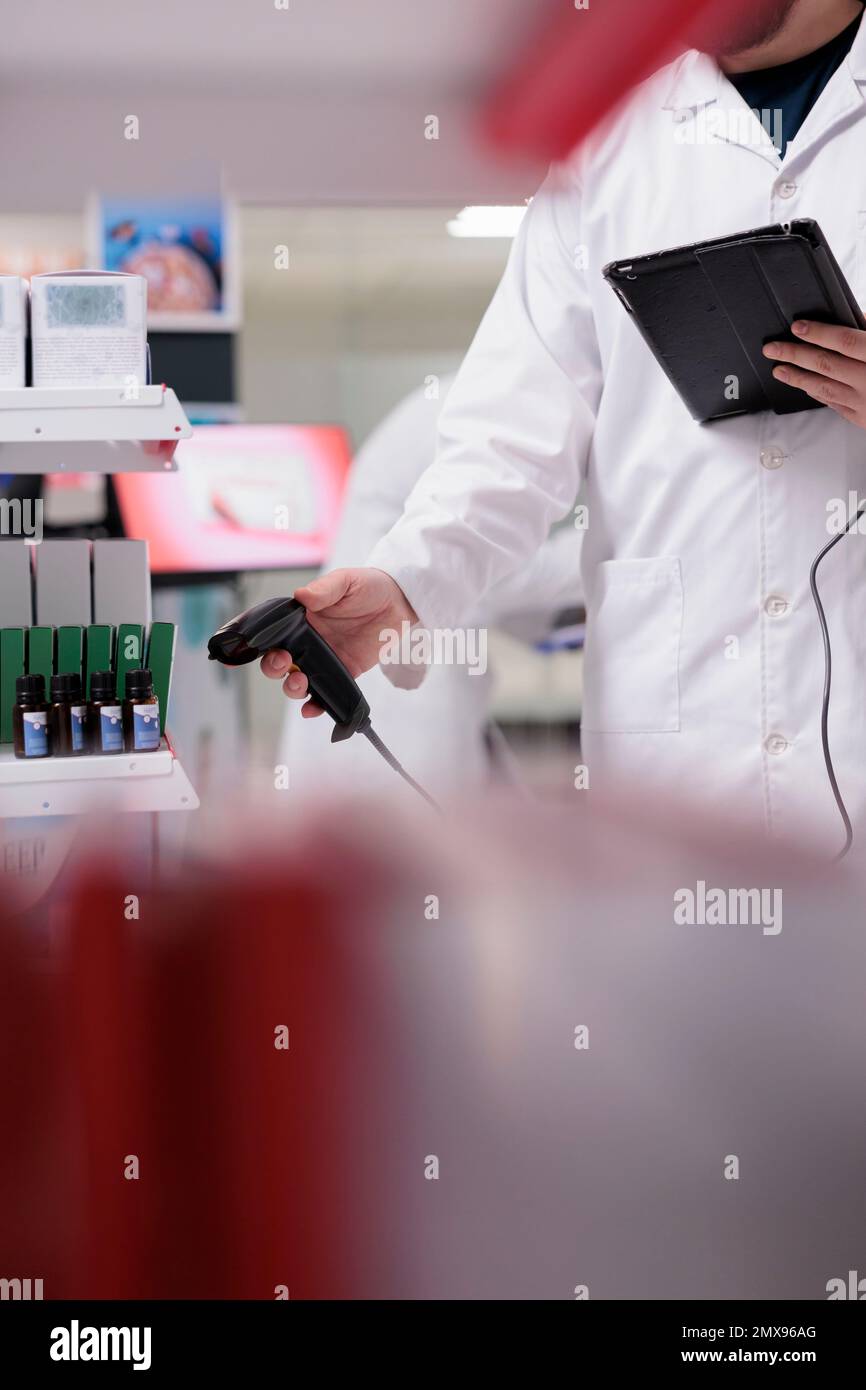 Worker scanning healthcare products with store scanner while verifies ...