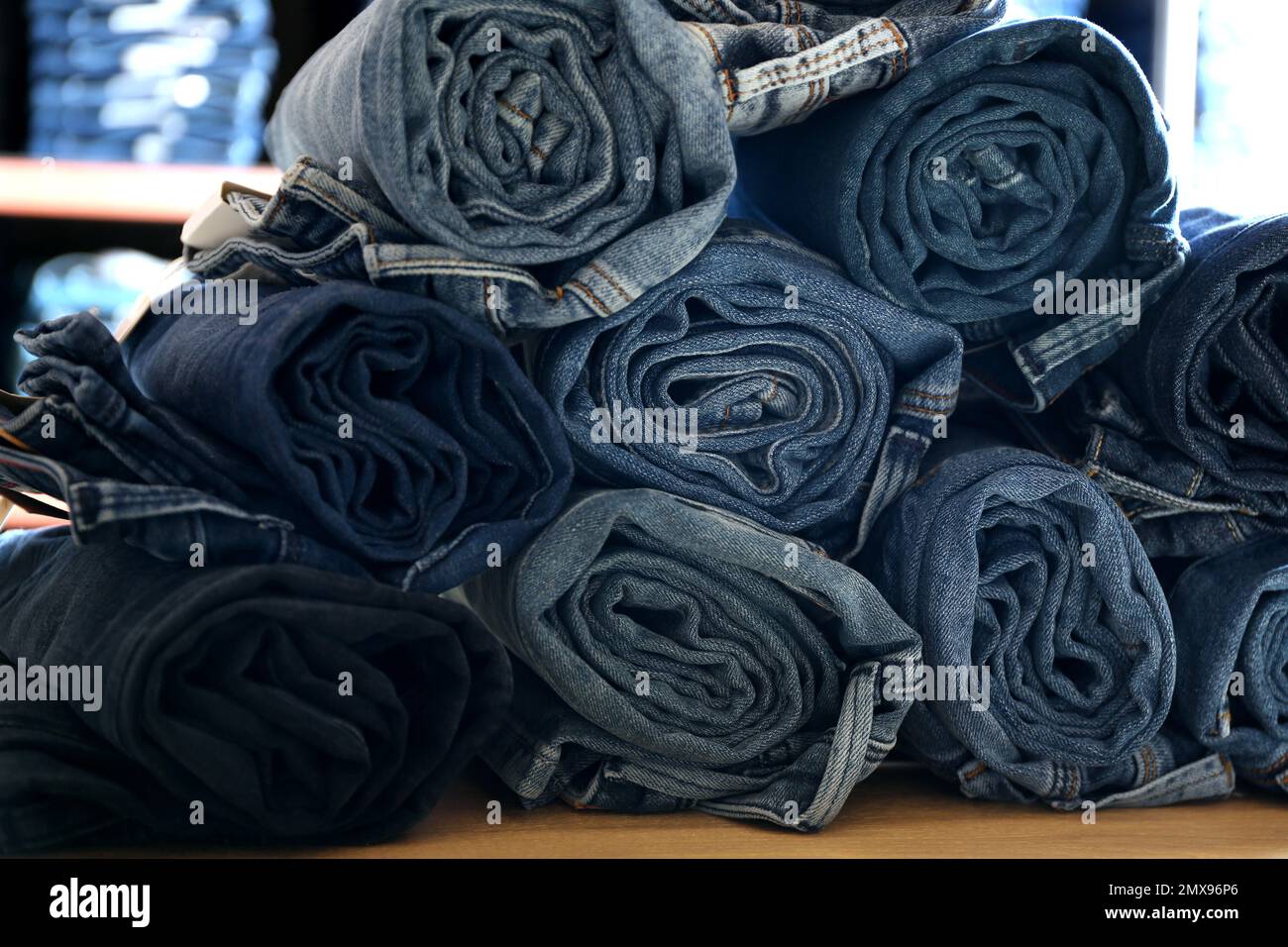 Rolled modern jeans on display in shop, closeup Stock Photo - Alamy