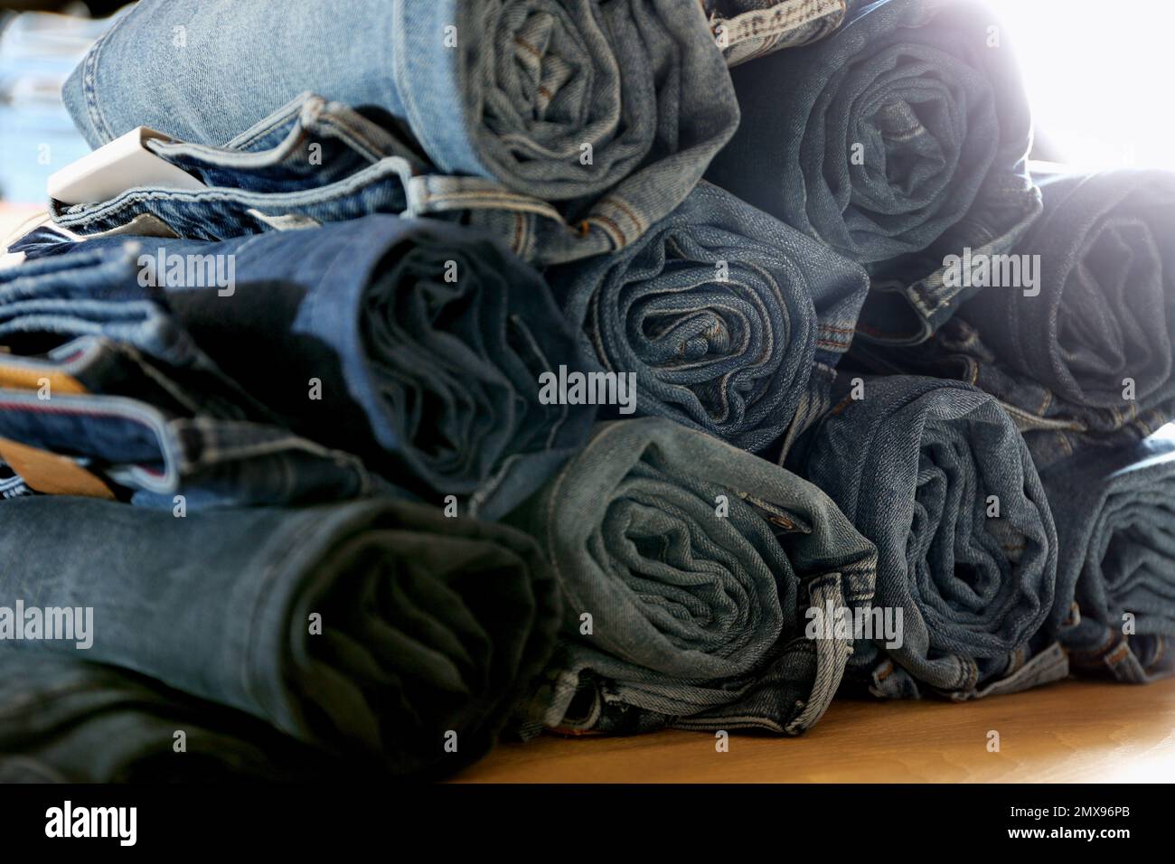 Rolled modern jeans on display in shop, closeup Stock Photo - Alamy
