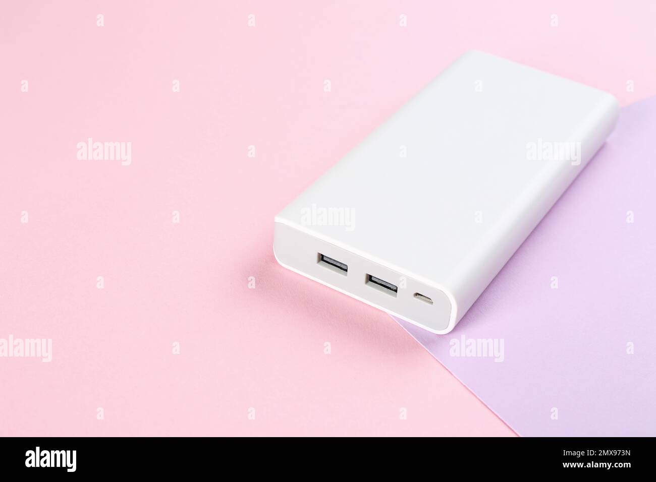 Modern external portable charger on color background. Space for text ...