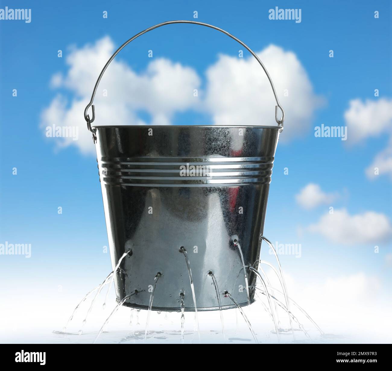 Leaky bucket with water against blue sky Stock Photo - Alamy
