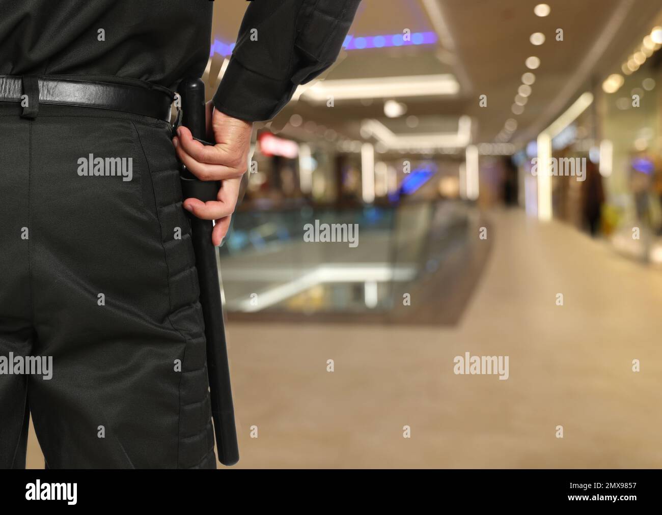 Security guard in uniform with police baton in shopping mall, closeup ...