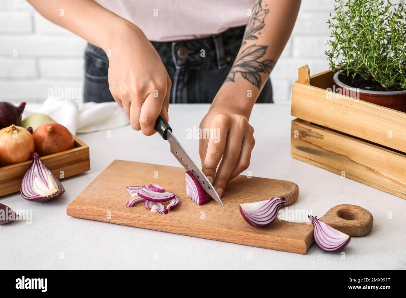 Woman cutting fresh onion hi-res stock photography and images - Alamy