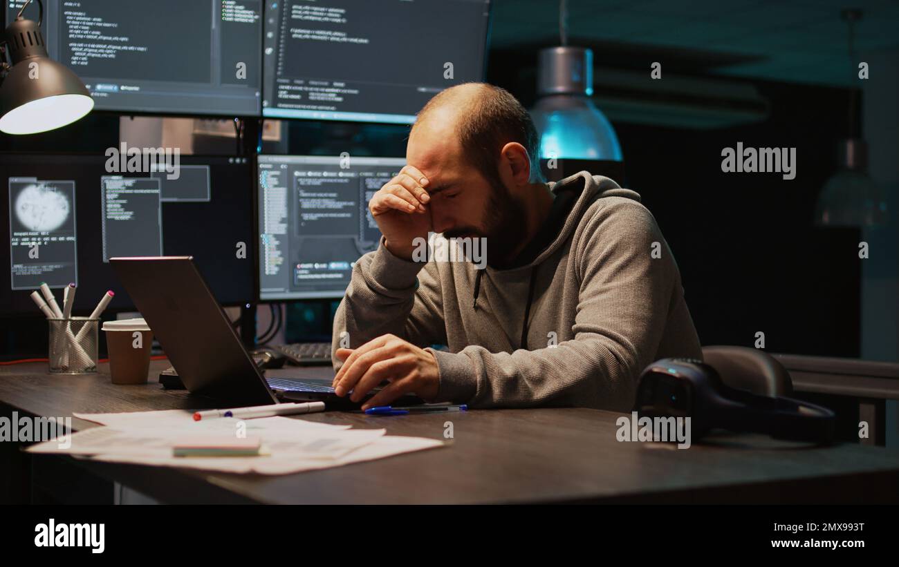 Male Coder Feeling Sleepy And Working On Programming Code Typing Database Information And Html