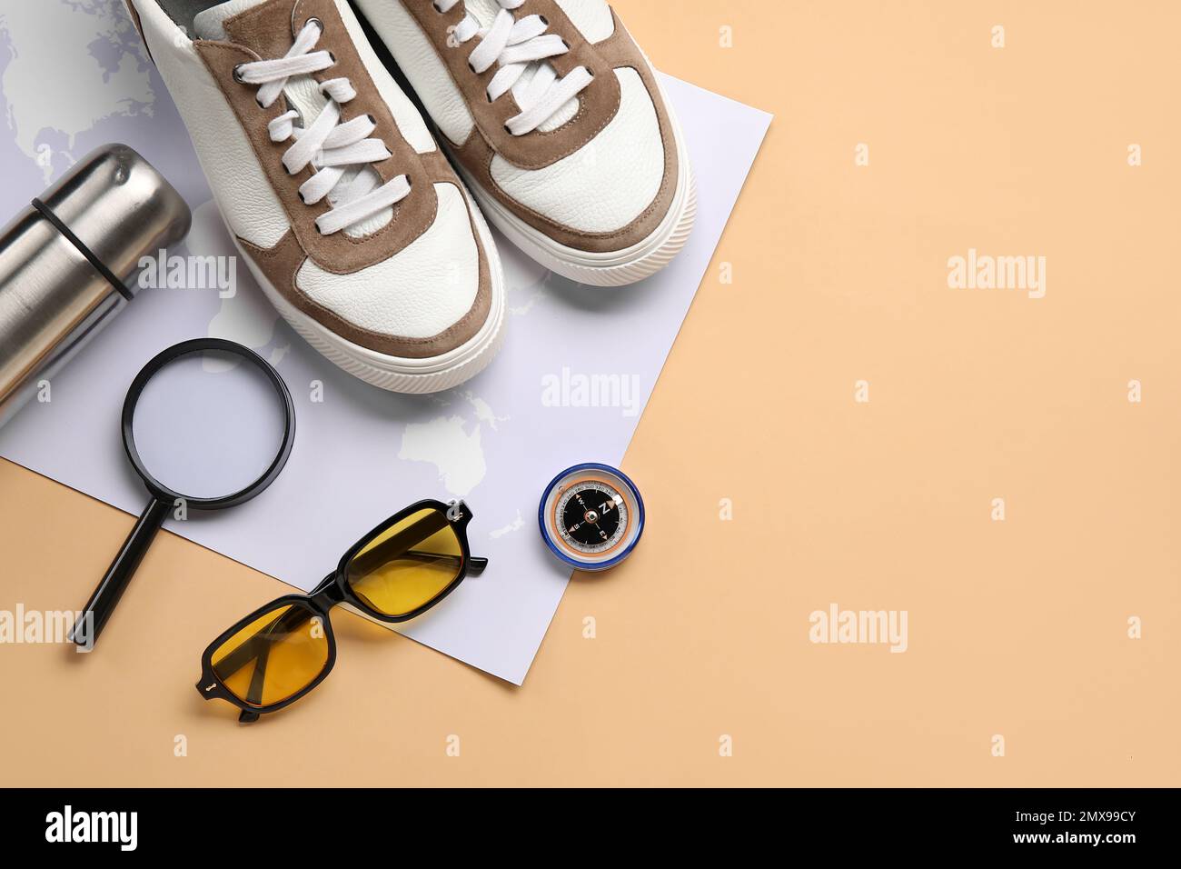 Compass with traveler accessories on beige background Stock Photo - Alamy