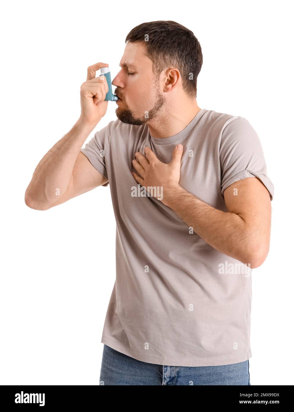Sick man with inhaler on white background Stock Photo - Alamy