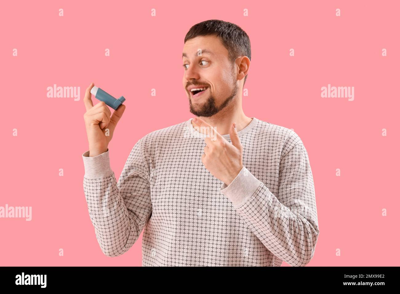 Man with inhaler on pink background Stock Photo - Alamy