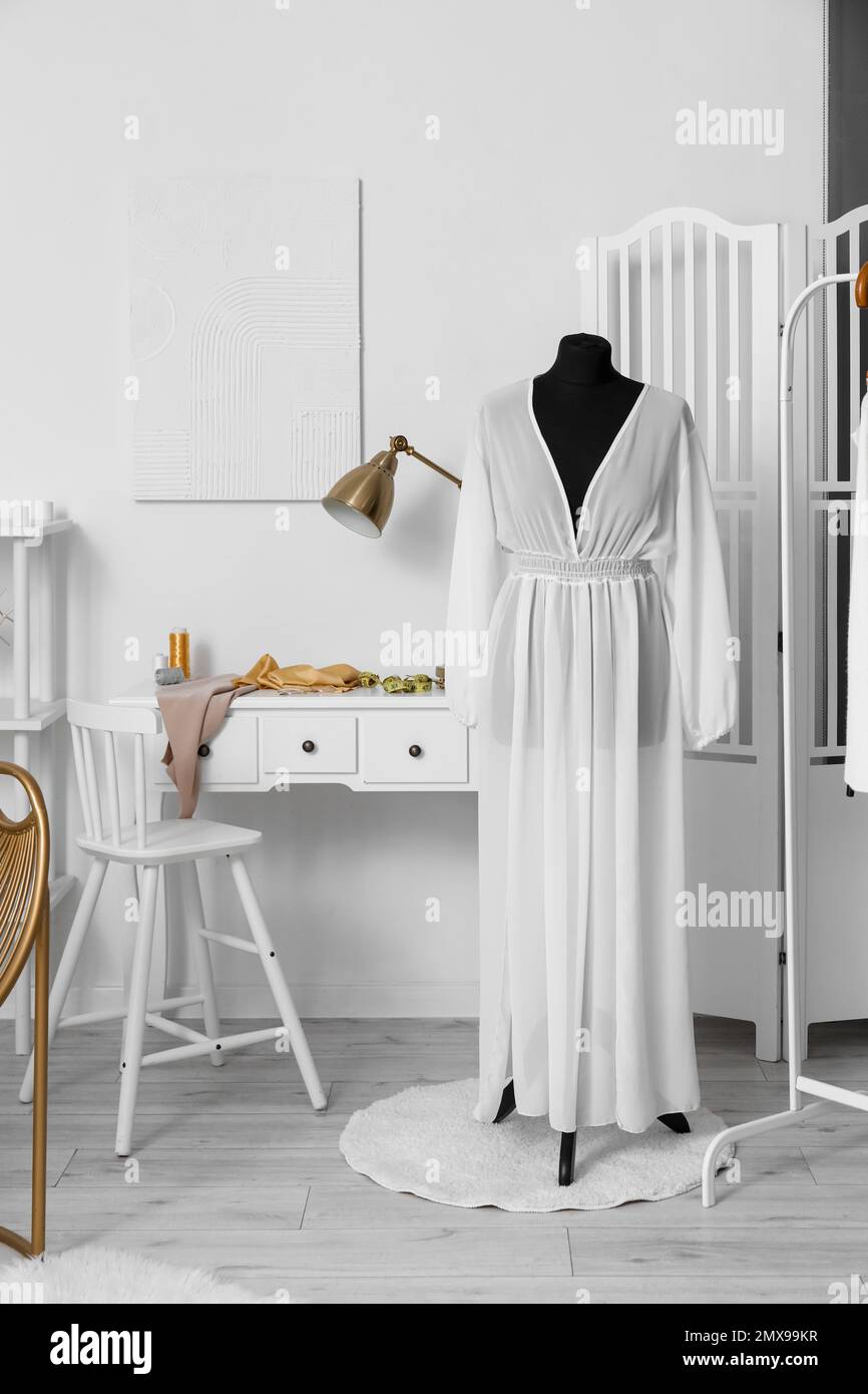Interior of fashion designer's studio with mannequin, workplace and ...