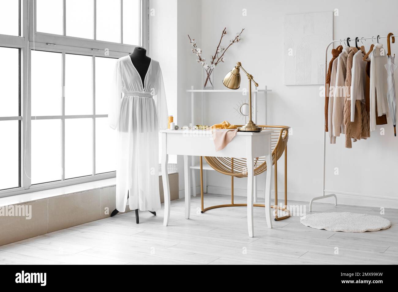 Interior of fashion designer's studio with mannequin, workplace and ...