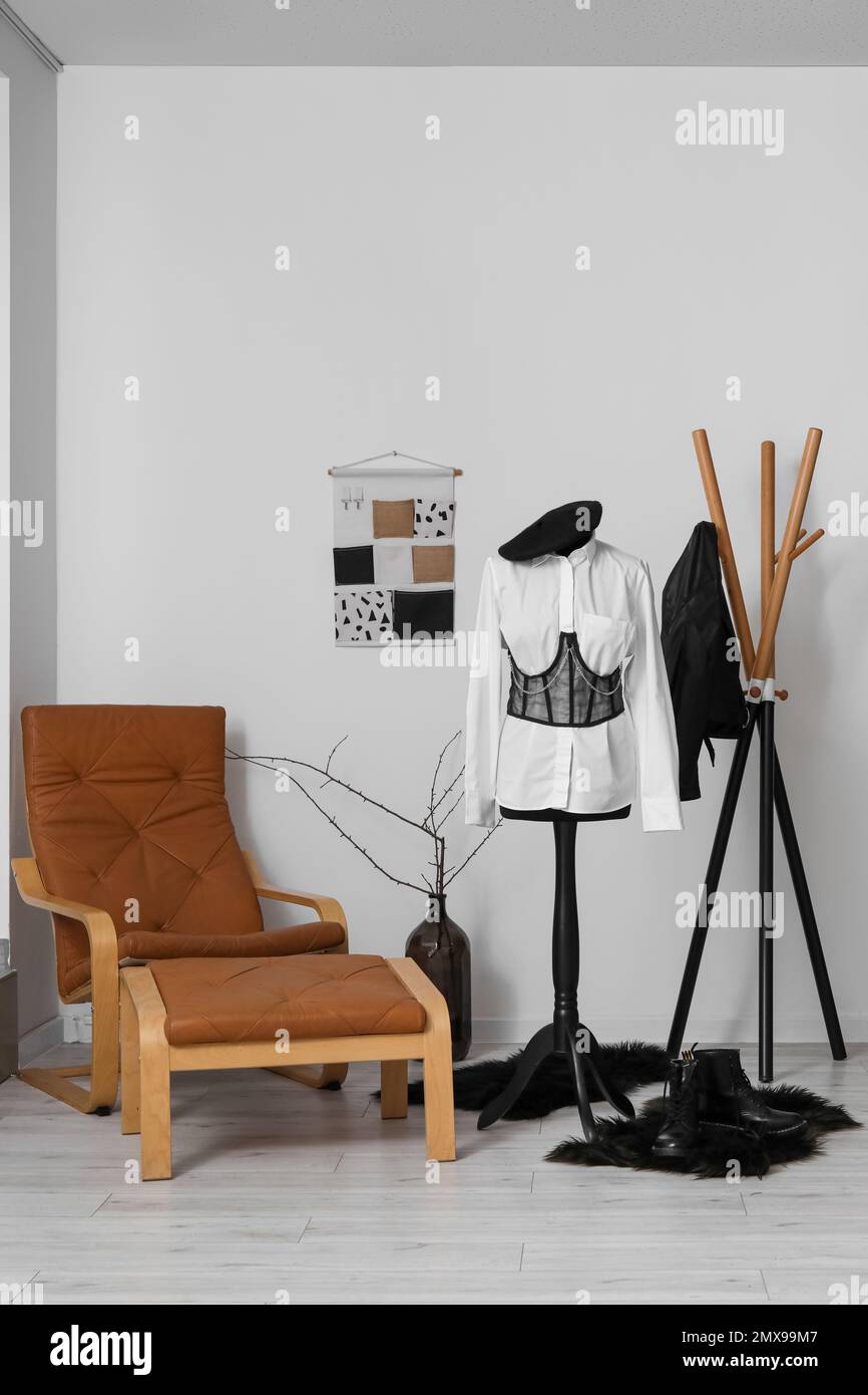 Interior of fashion designer's studio with mannequin, clothes and ...