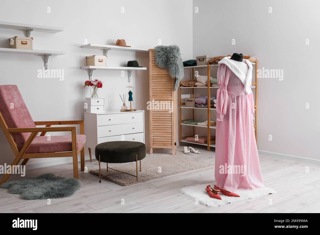 Interior of fashion designer's studio with mannequin, clothes and ...