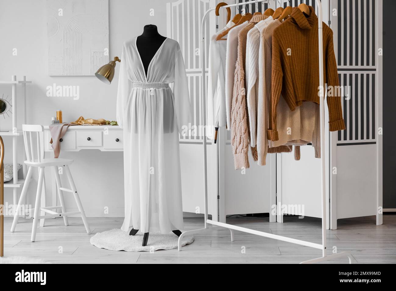 Interior of fashion designer's studio with mannequin, workplace and ...