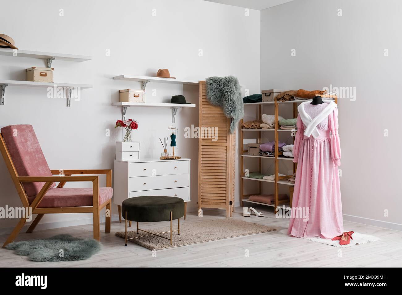 Interior of fashion designer's studio with mannequin, clothes and ...