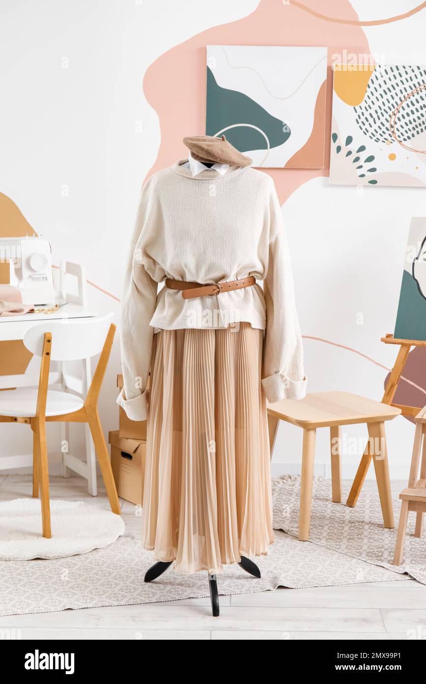 Interior of fashion designer's studio with mannequin, clothes and ...