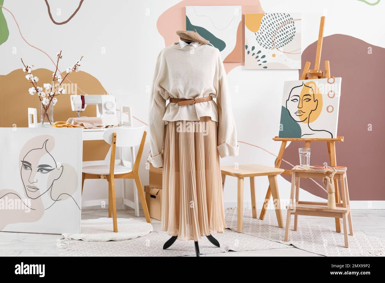 Interior of fashion designer's studio with mannequin, clothes and ...