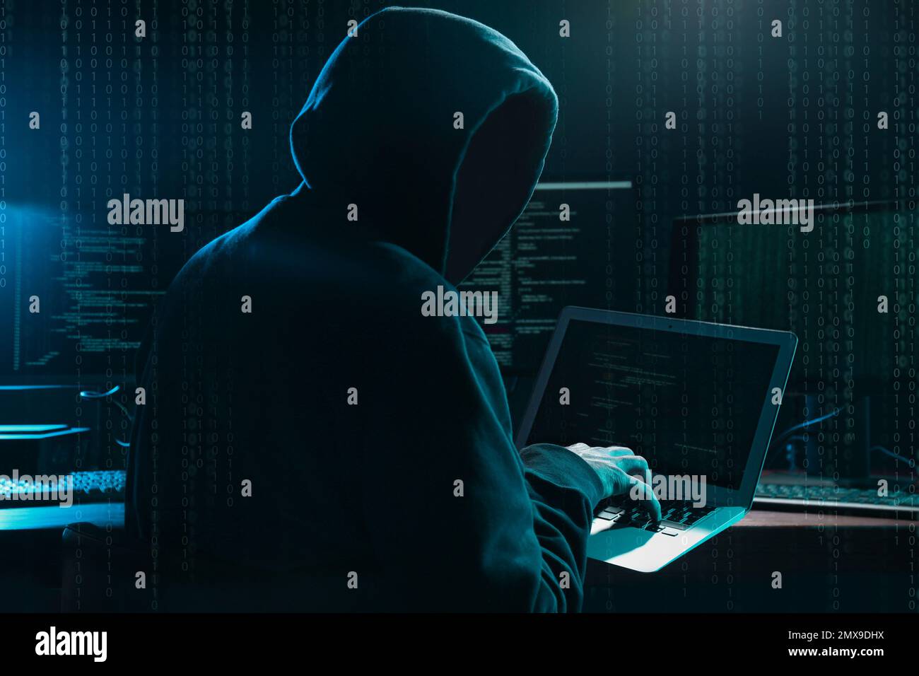 Cyber criminal hacking system at table, digital binary code on ...