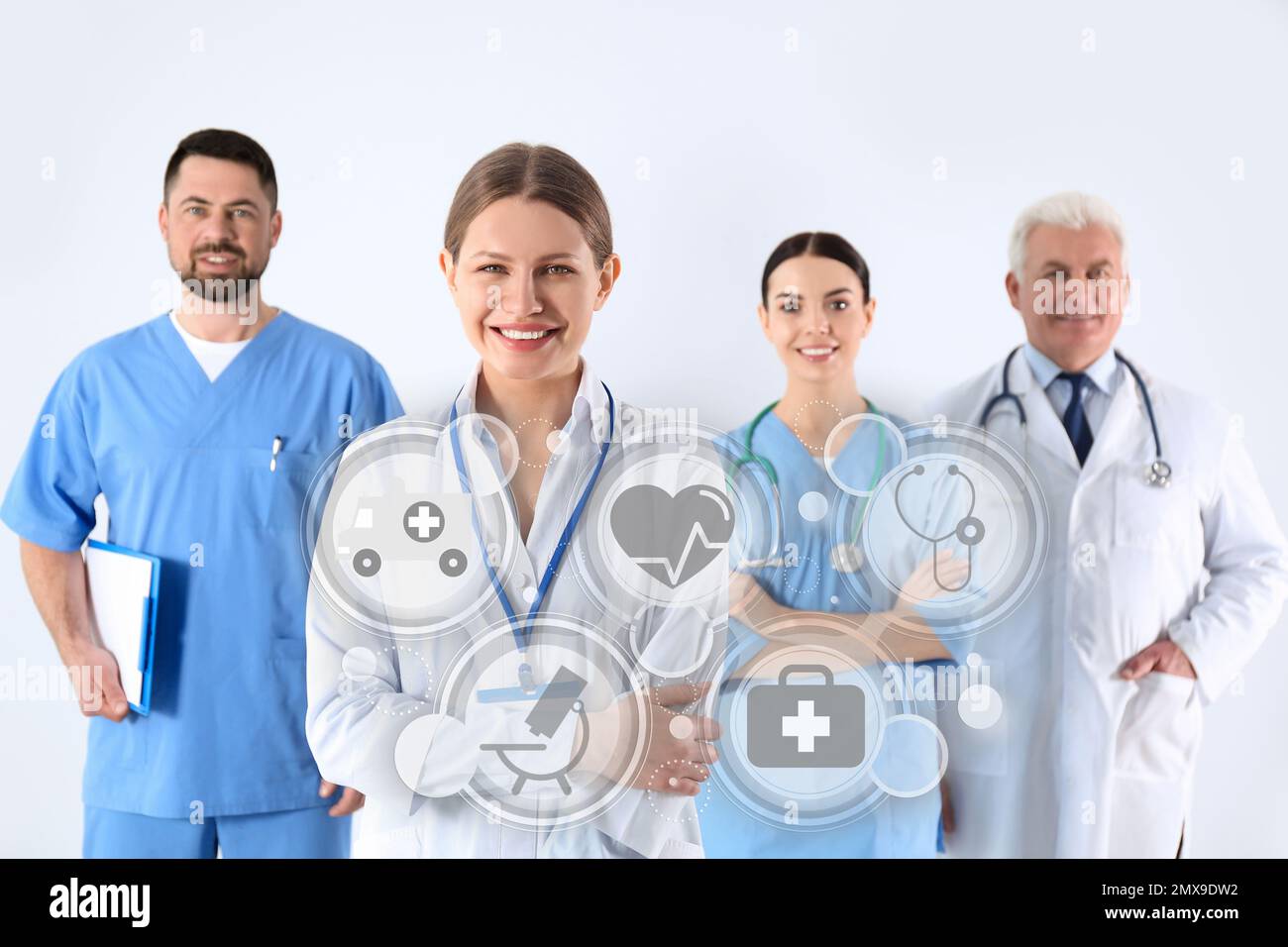 Group of doctors against light background. Medical service Stock Photo ...