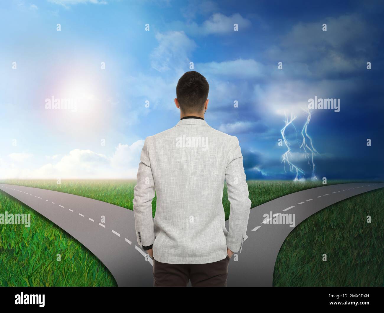 Man at crossroads choosing between sunny and stormy ways Stock Photo ...