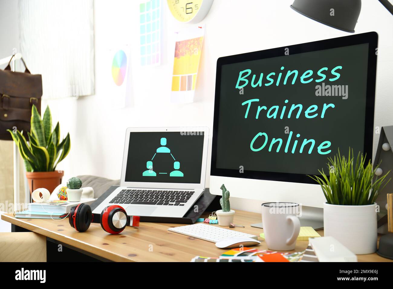 Modern computer and laptop on desk indoors. Business trainer online ...