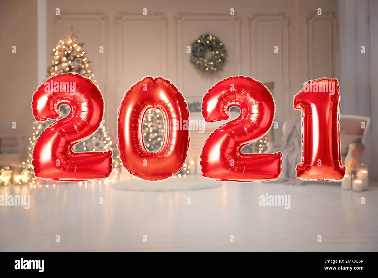 Red foil 2021 balloons in festive room interior Stock Photo - Alamy