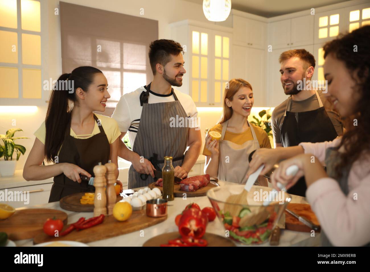 Happy people cooking food together in kitchen Stock Photo - Alamy