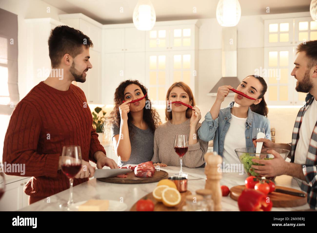 Happy people having fun while cooking food in kitchen Stock Photo - Alamy