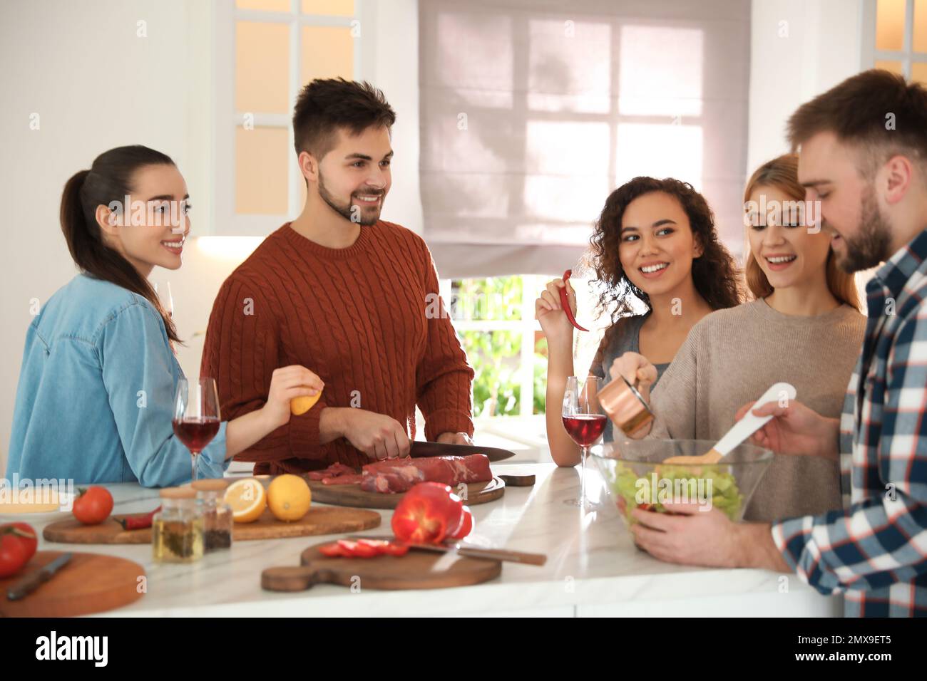 Happy people cooking food together in kitchen Stock Photo - Alamy