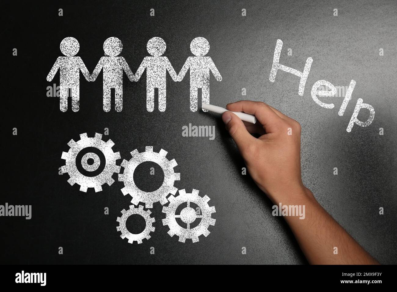 Team work concept. Man drawing people figures on chalkboard Stock Photo ...