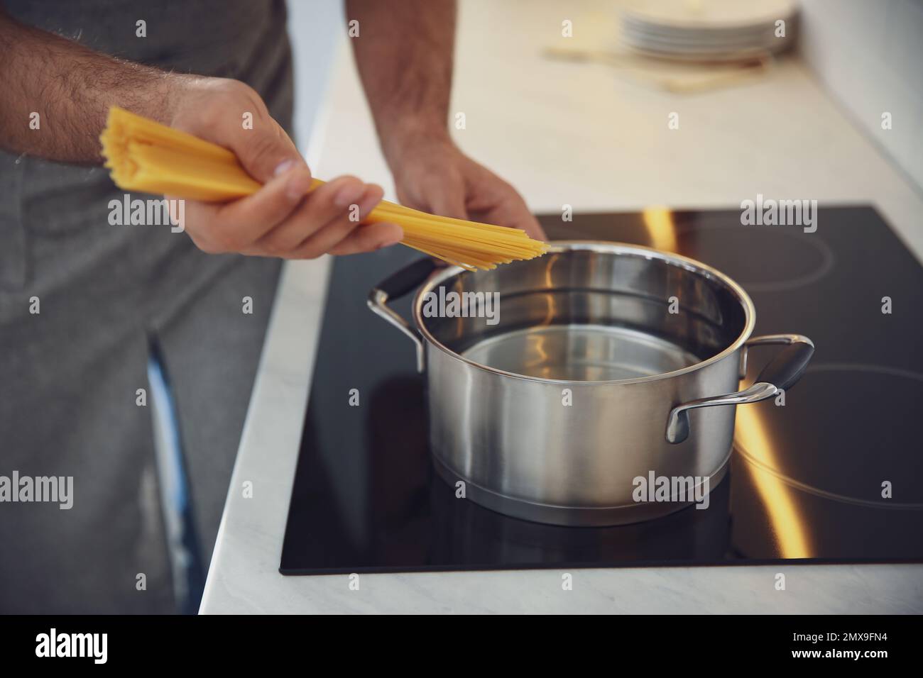 Male hands cooking on stove hi-res stock photography and images - Alamy