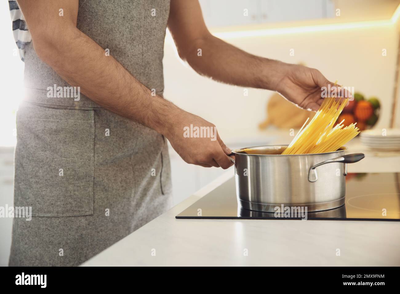 Male hands cooking on stove hi-res stock photography and images - Alamy