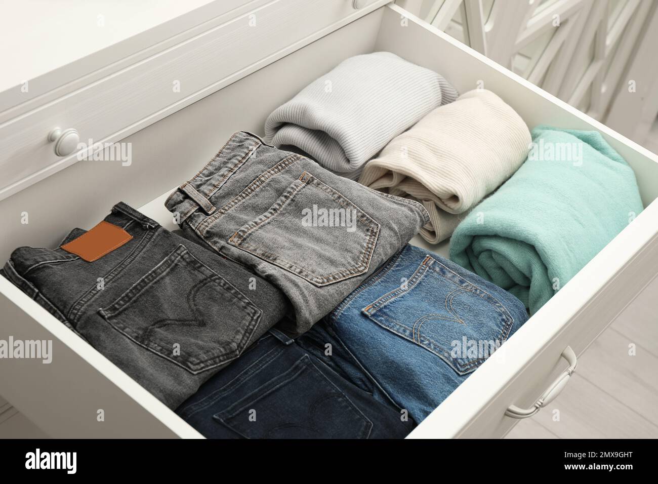 Folded clothes in open drawer. Apparel storage Stock Photo - Alamy
