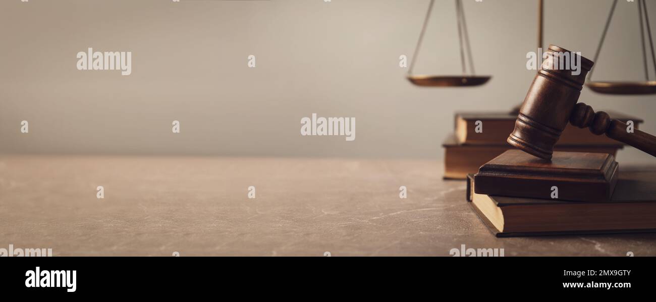 Wooden gavel with scales of justice and books on lawyer's table, space ...
