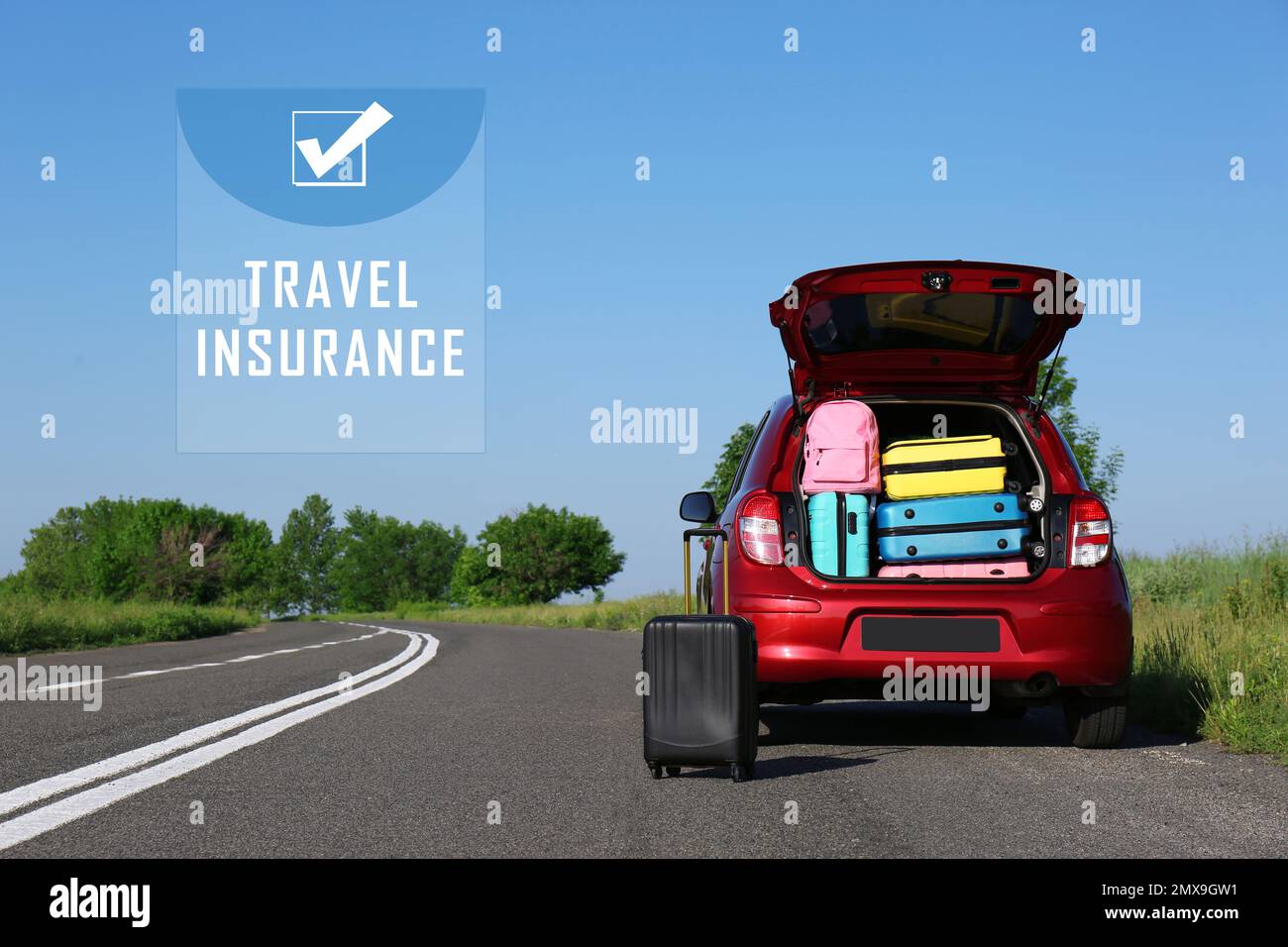Suitcase near family car with open trunk full of luggage on highway ...