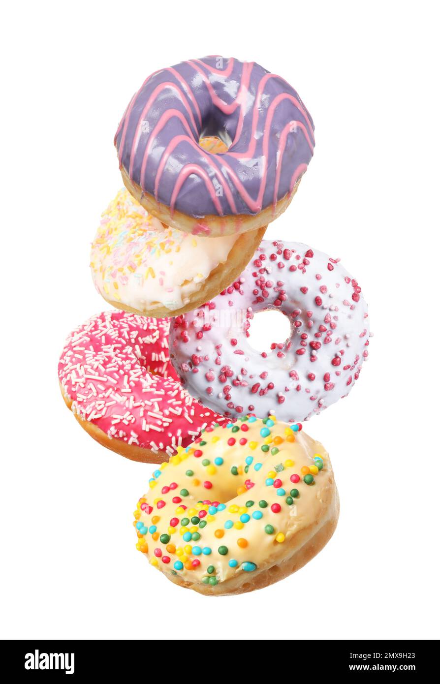 Set of falling delicious donuts on white background Stock Photo - Alamy