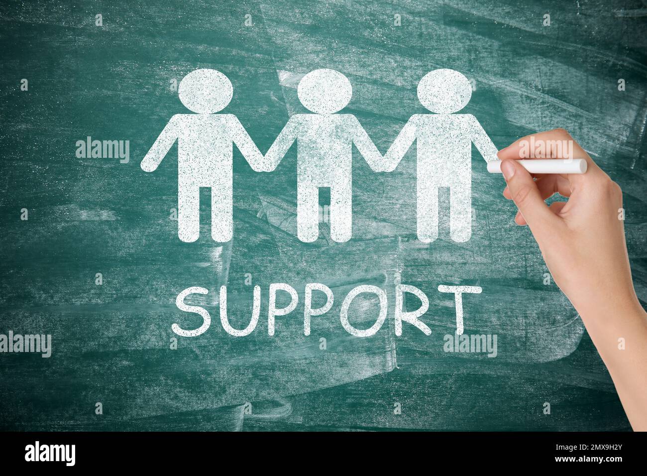 Team work concept. Woman drawing people figures on chalkboard Stock ...