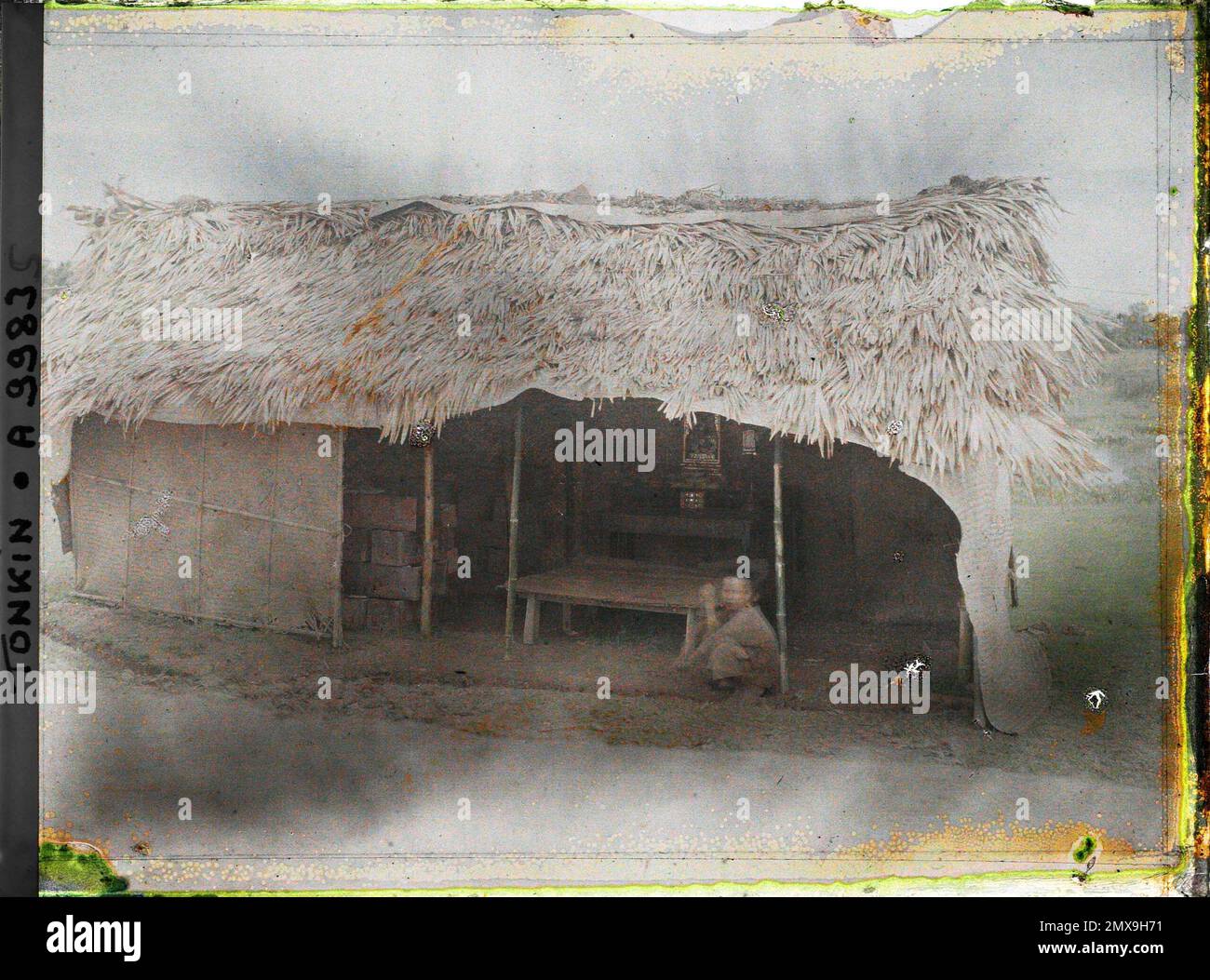 Tonkin, Indochina a hut temporarily housing bones during exhumation ...