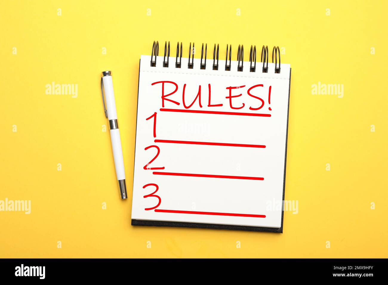 Notebook with list of rules and pen on yellow background, flat lay ...