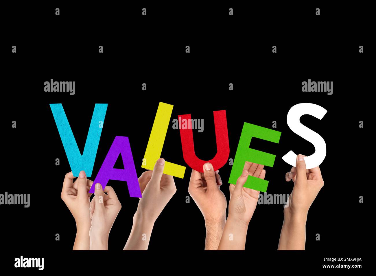 People making word VALUES of letters on black background Stock Photo ...