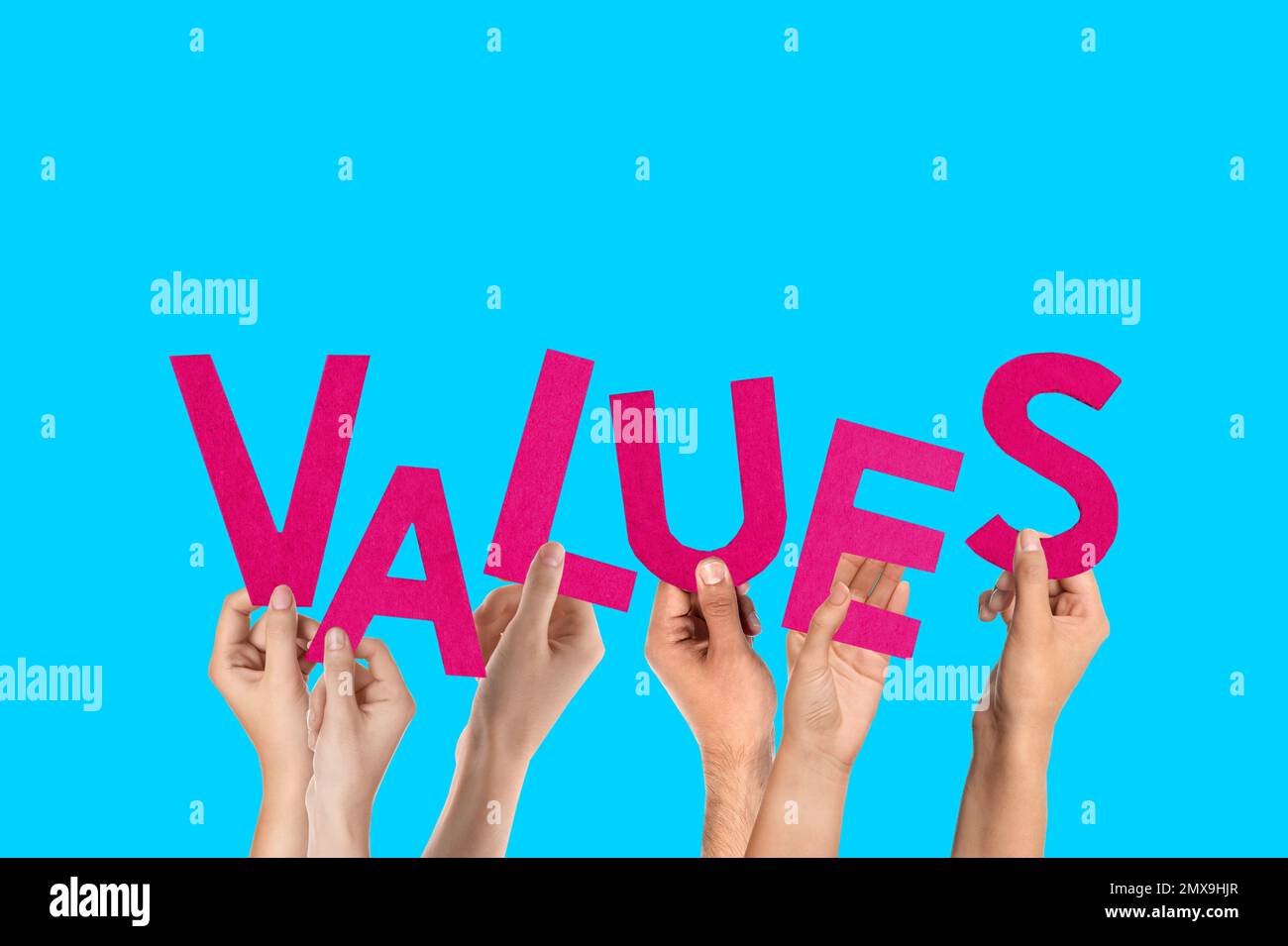 People making word VALUES of letters on blue background Stock Photo - Alamy