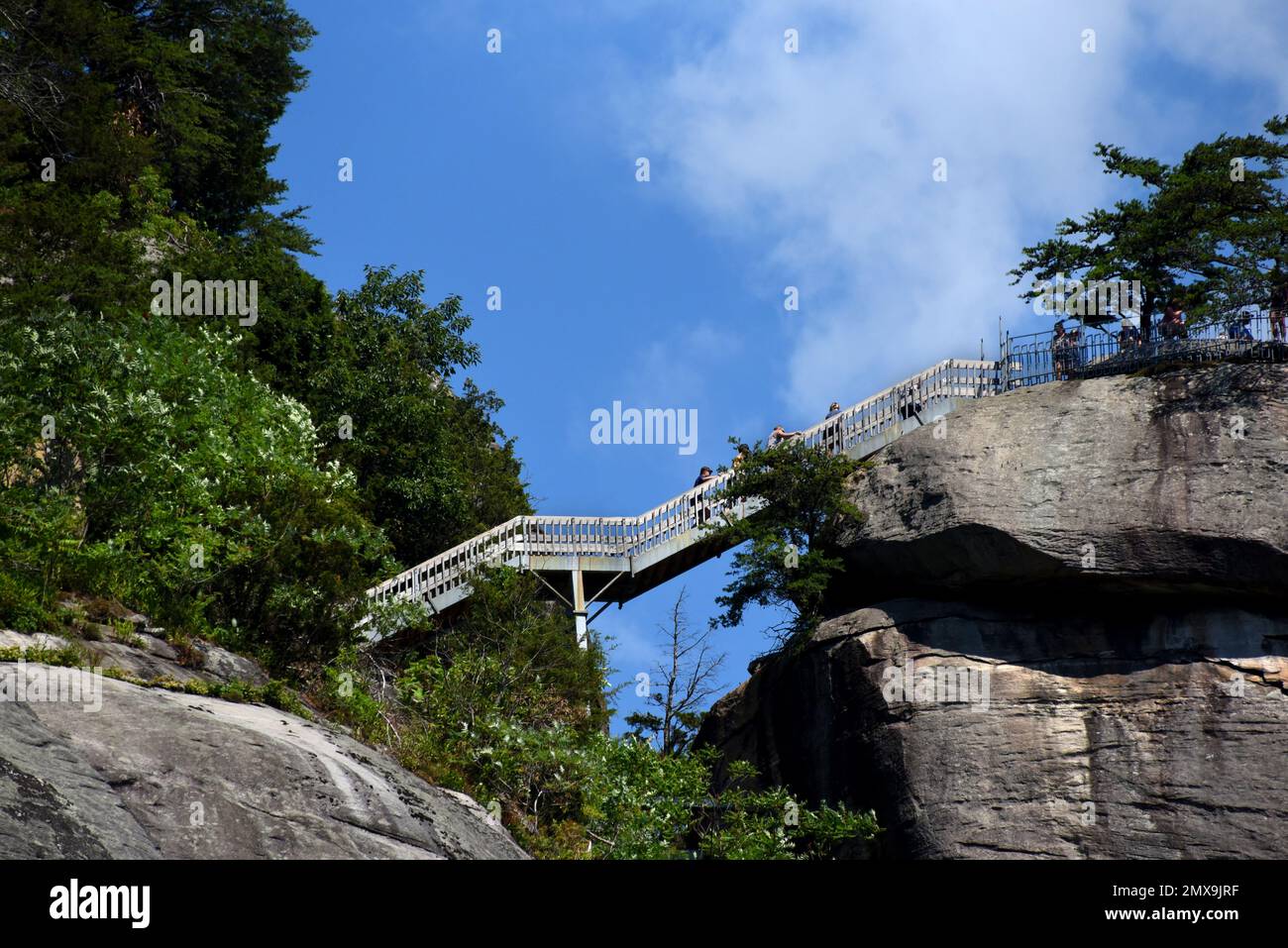 White bridge gives visitors access to Chimney Rock from general viewing ...