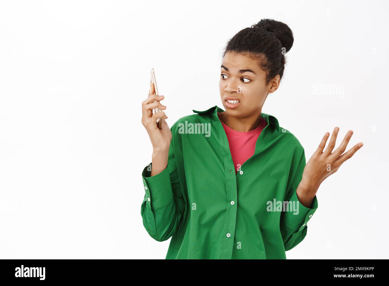 Portrait of woman shocked at someone screaming on phone, looking ...