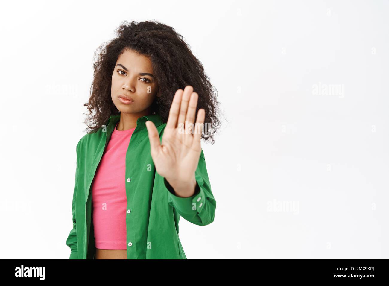 Stop it. Serious and confident young woman shows block, taboo gesture ...